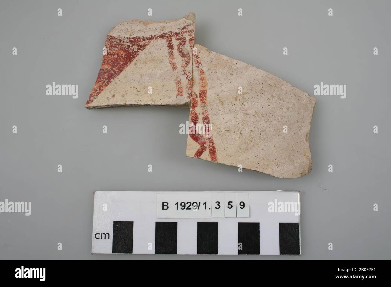A wall shard, cream slid and decorated with red paint., Crockery ...