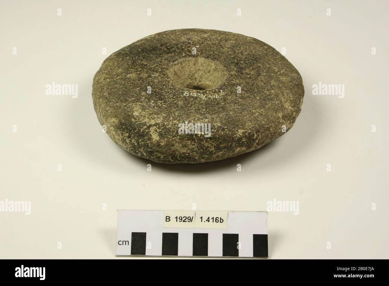 A virtually round disc with a hole. The hole is drilled from both sides ...