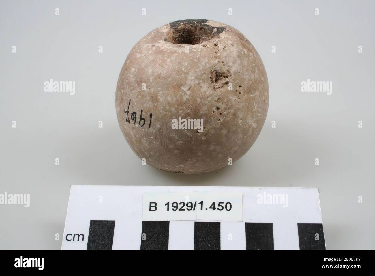 A round smooth stone with a biconcaver hole. Probably used as weight ...