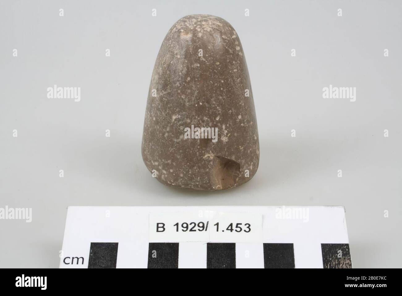 A conical shaped stone with a hole in the wide end. Function unknown ...