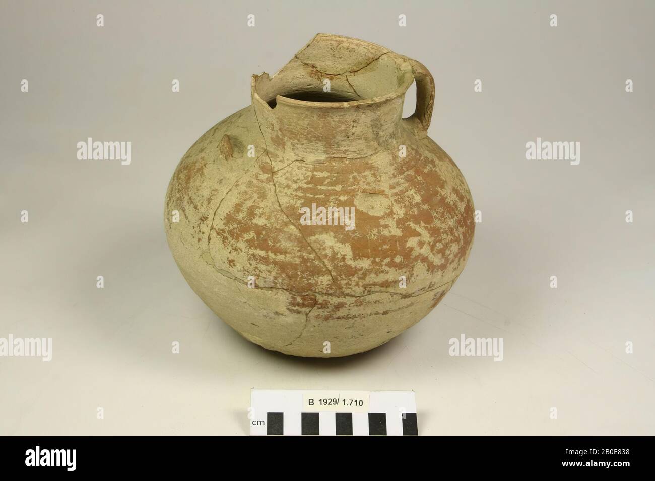 A cooking pot with two handles and a vertical neck. The end of the edge ...