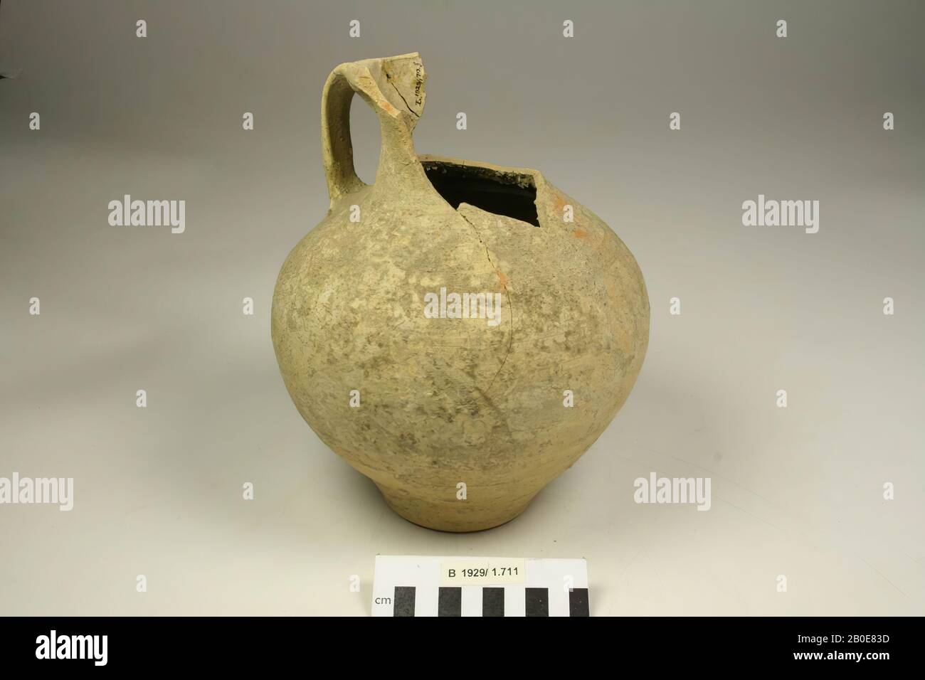 Jar of earthenware. Traces of red paint are visible. Bonded with shard ...