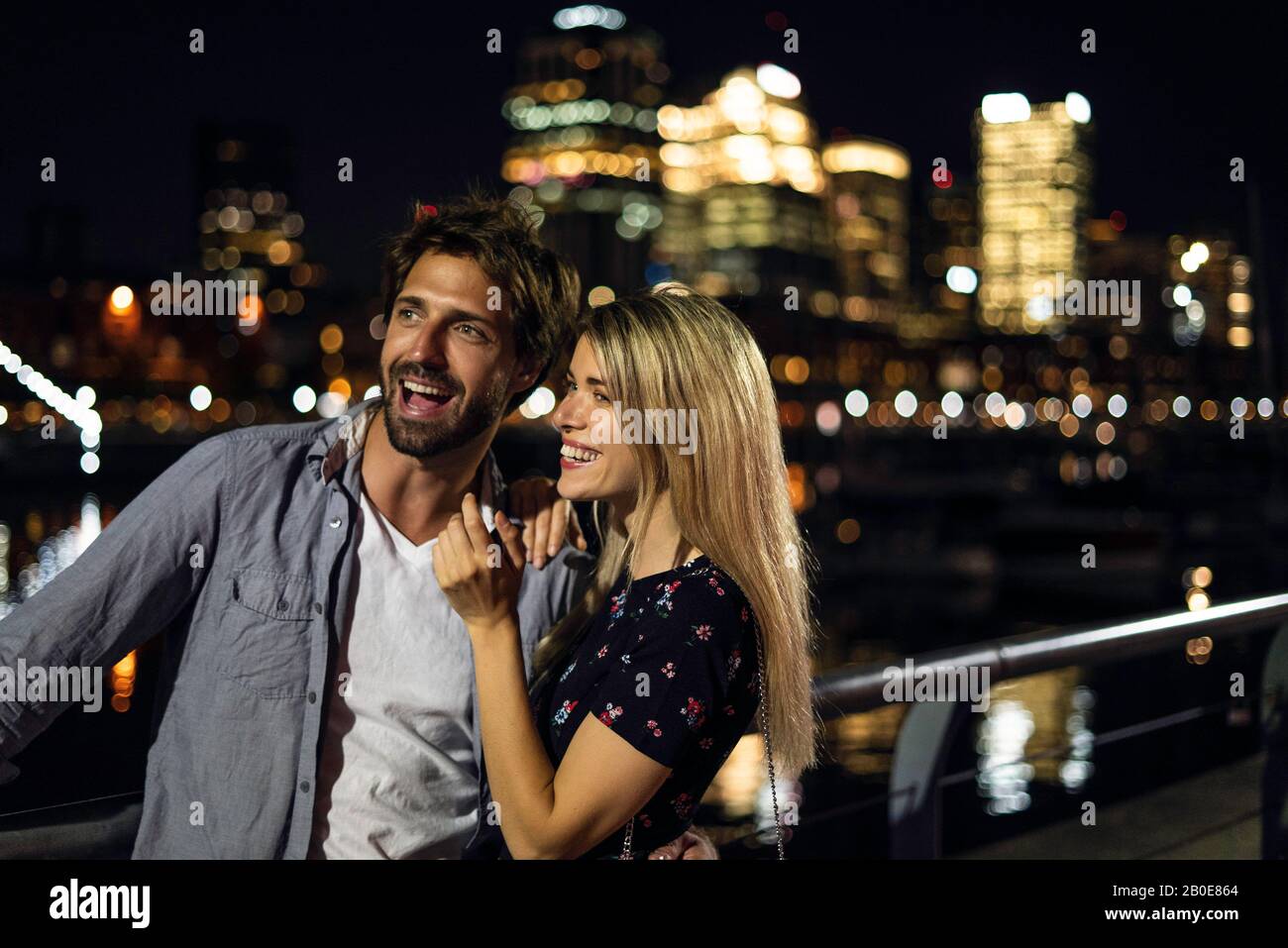Young couple standing outdoors at night Stock Photo - Alamy