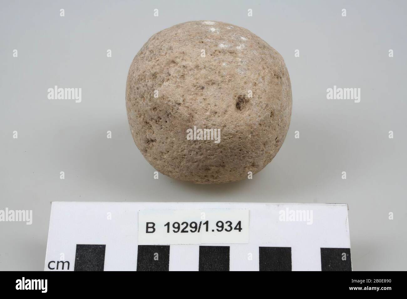 A round stone, probably used as a pestle or pillar stone, grindstone ...