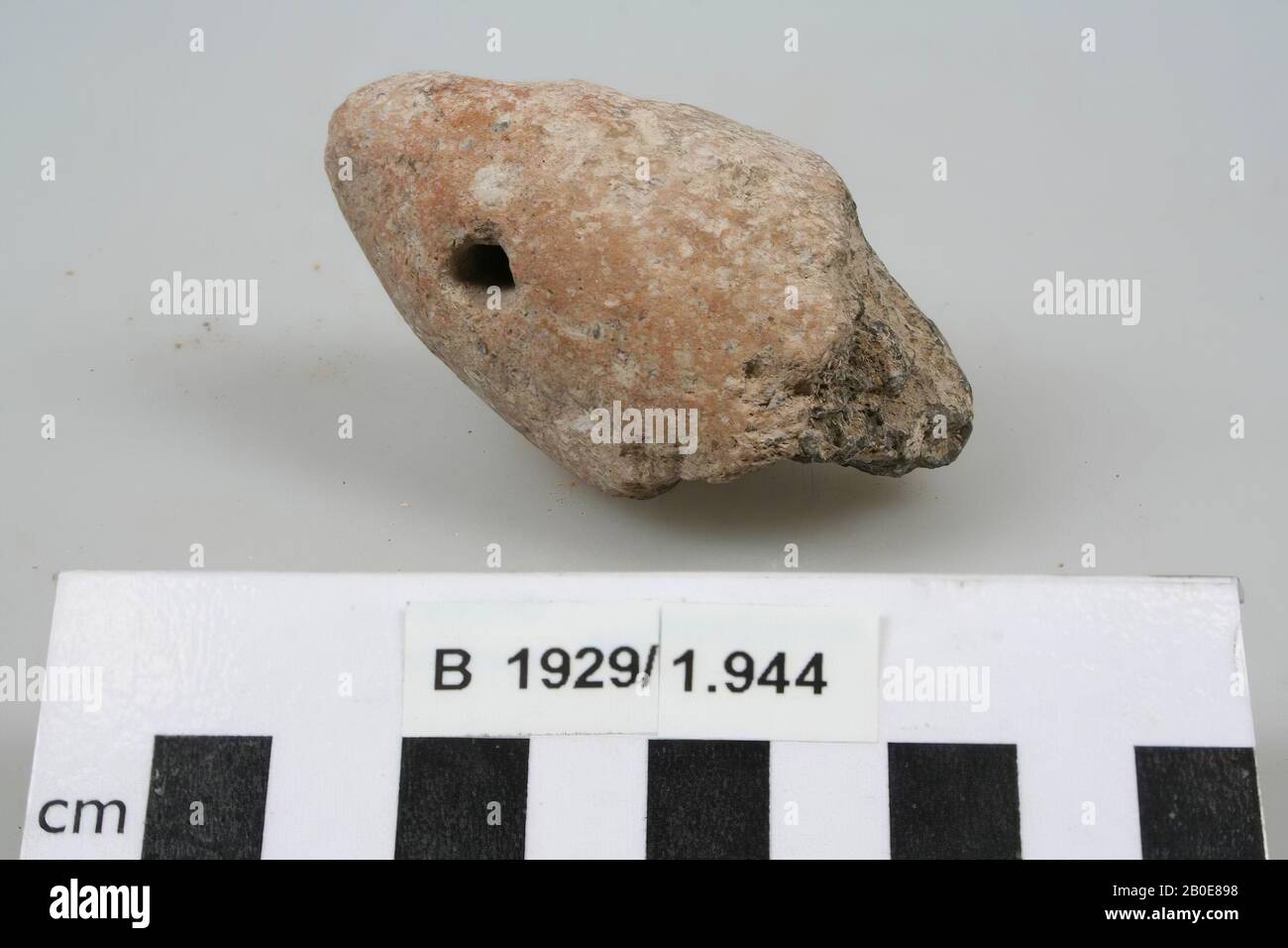 A fragment of a conically shaped weaving weight. A large part of the ...