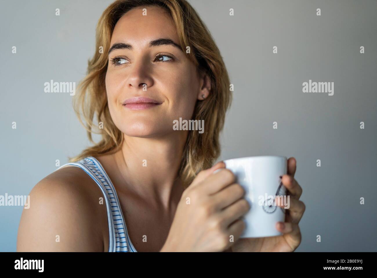 Smiling thoughtful woman coffee hi-res stock photography and images - Alamy