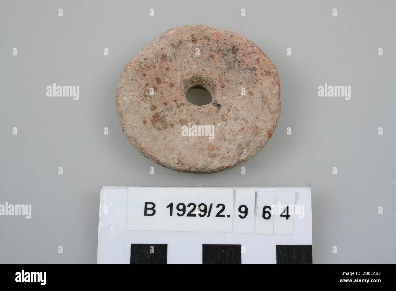 A disk-shaped spindle with a hourglass-shaped hole., Tool, stone, D 4.5 ...