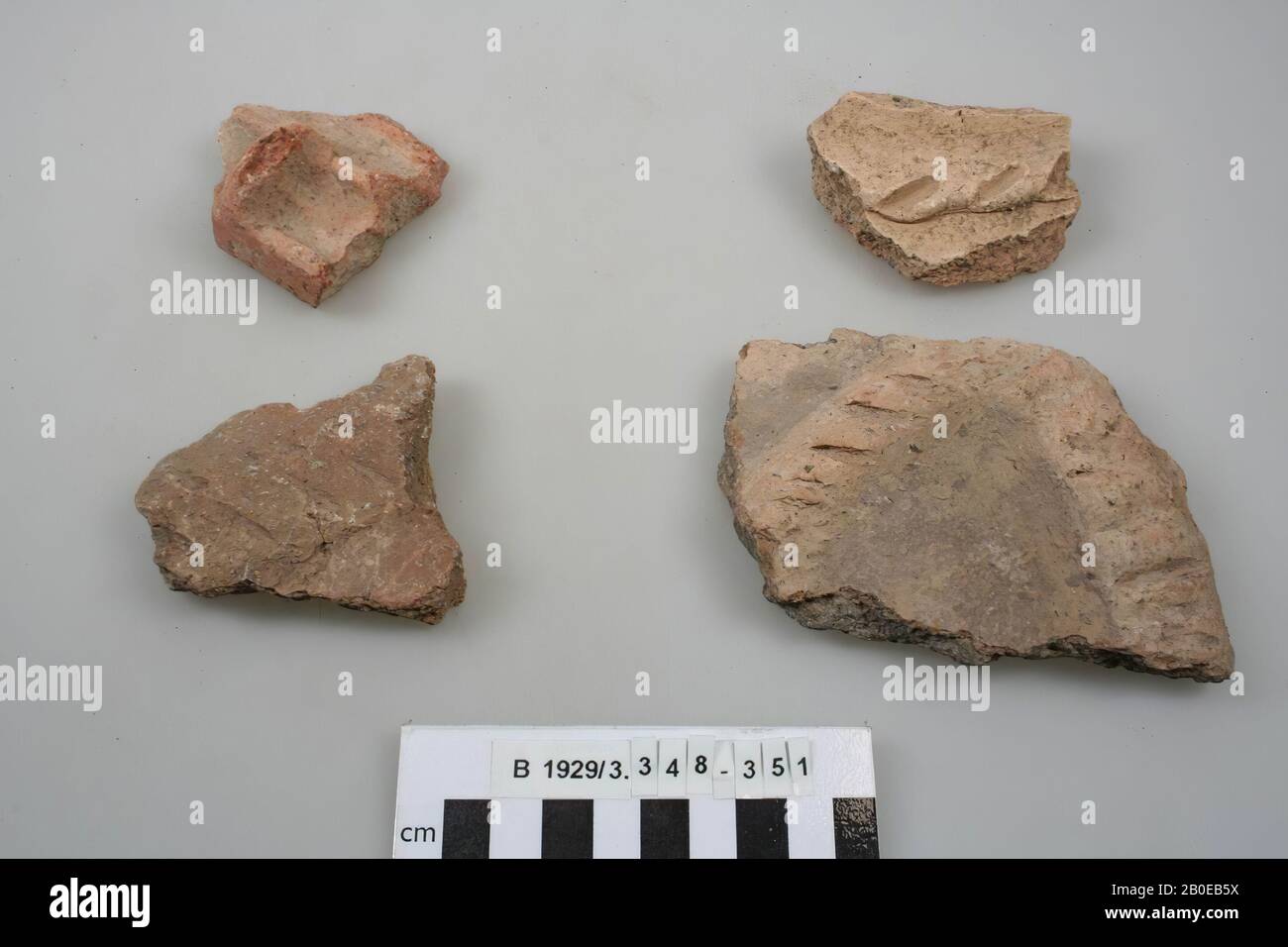A wall shard, decorated with a flattened roll of clay and notches ...