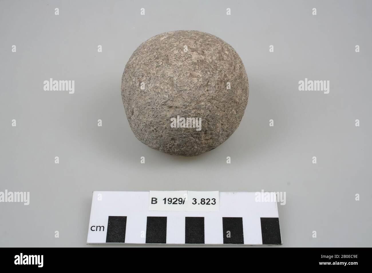 A round stone, probably used as a pestle or pillar stone, grindstone ...
