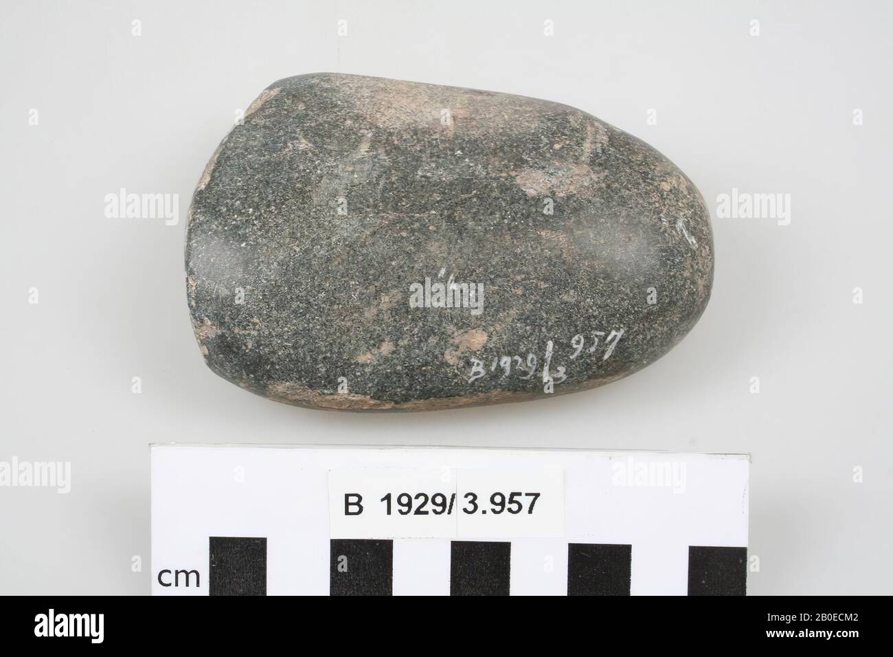 An oval shaped stone with one flattened side. Perhaps the stone is used ...