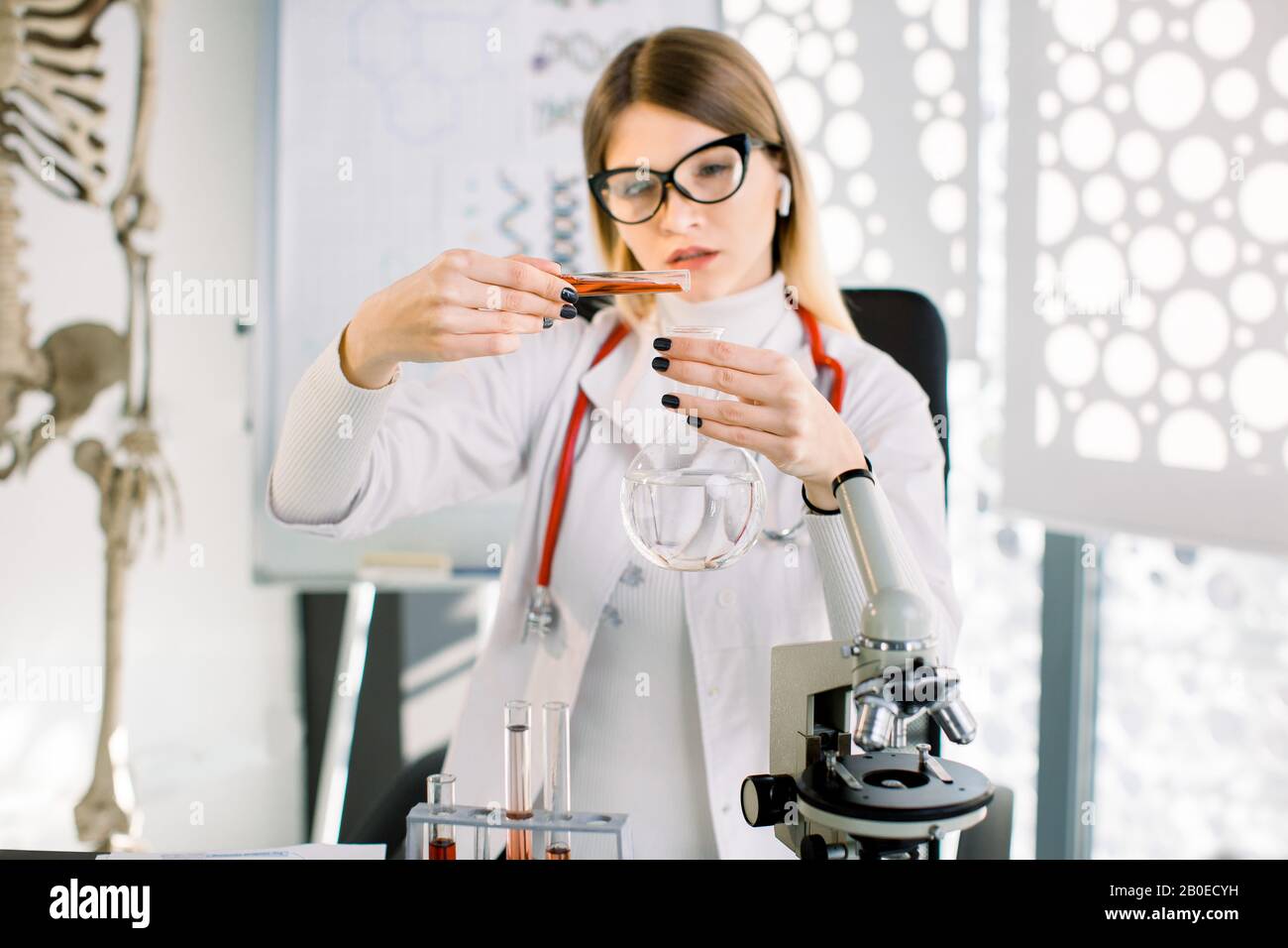 Close-up of female doctor clinician or young scientist working with ...