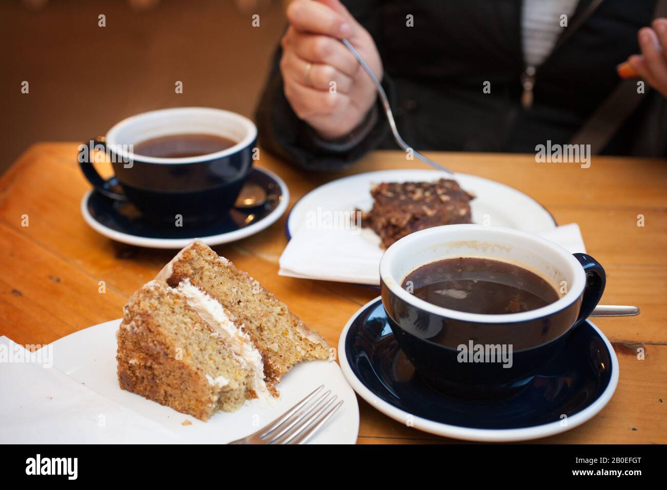 Coffee and cake in a cafe in front of friends Stock Photo - Alamy