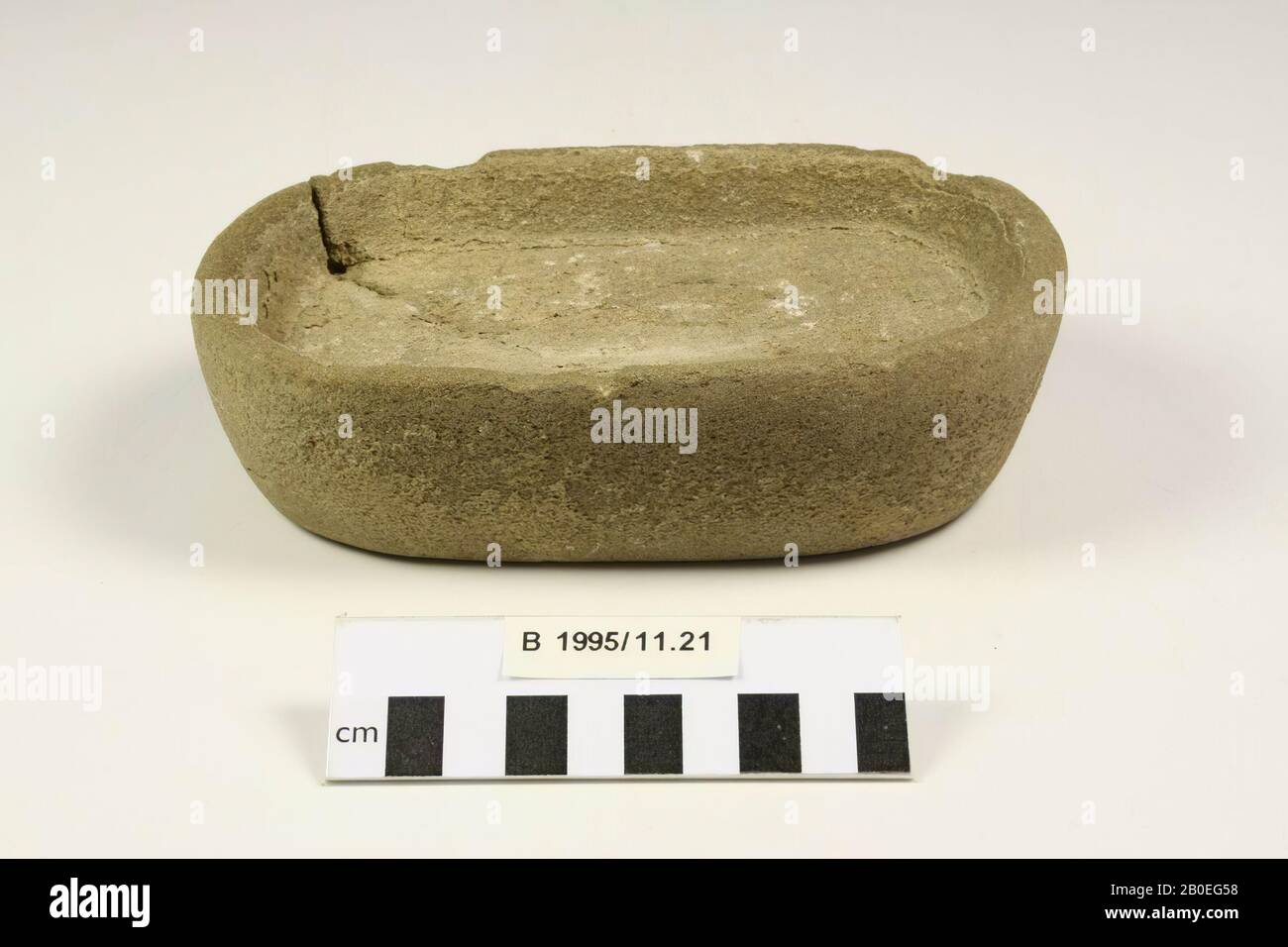 Mortar of stone with raised edge. Chips from the edge, vertical crack ...