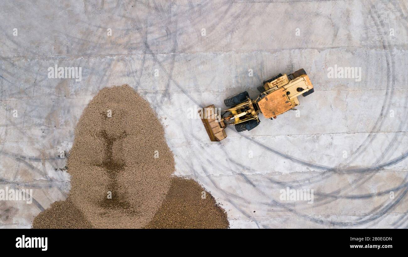 the loader loads the potatoes, top view Stock Photo - Alamy