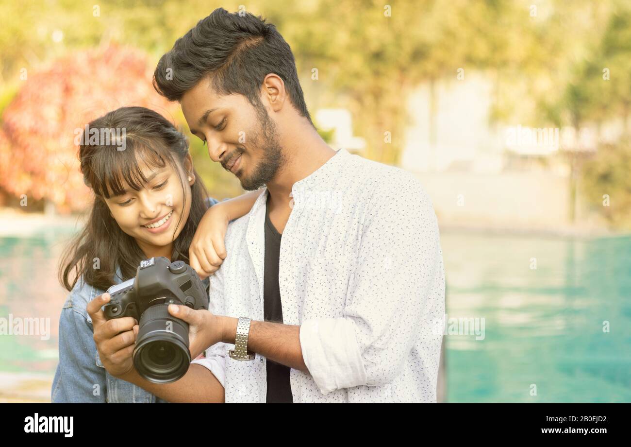 Cute Couple looking pictures on camera screen - Happy Young ...