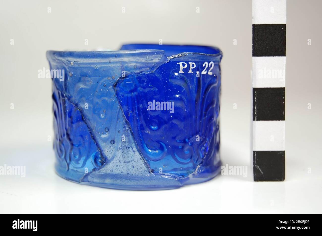 Three fragments of Roman-Syrian molded pyxis, of transparent, dark blue ...