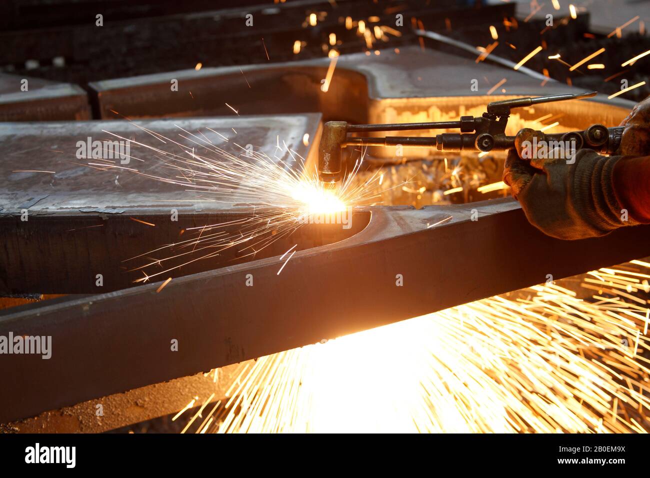 Industrial worker welding in steel factory Stock Photo - Alamy