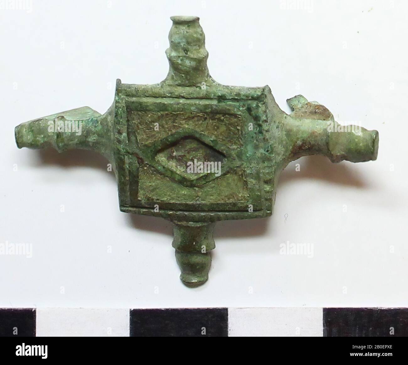 Bronze enamel fibula, square with four points. On the shield a window ...