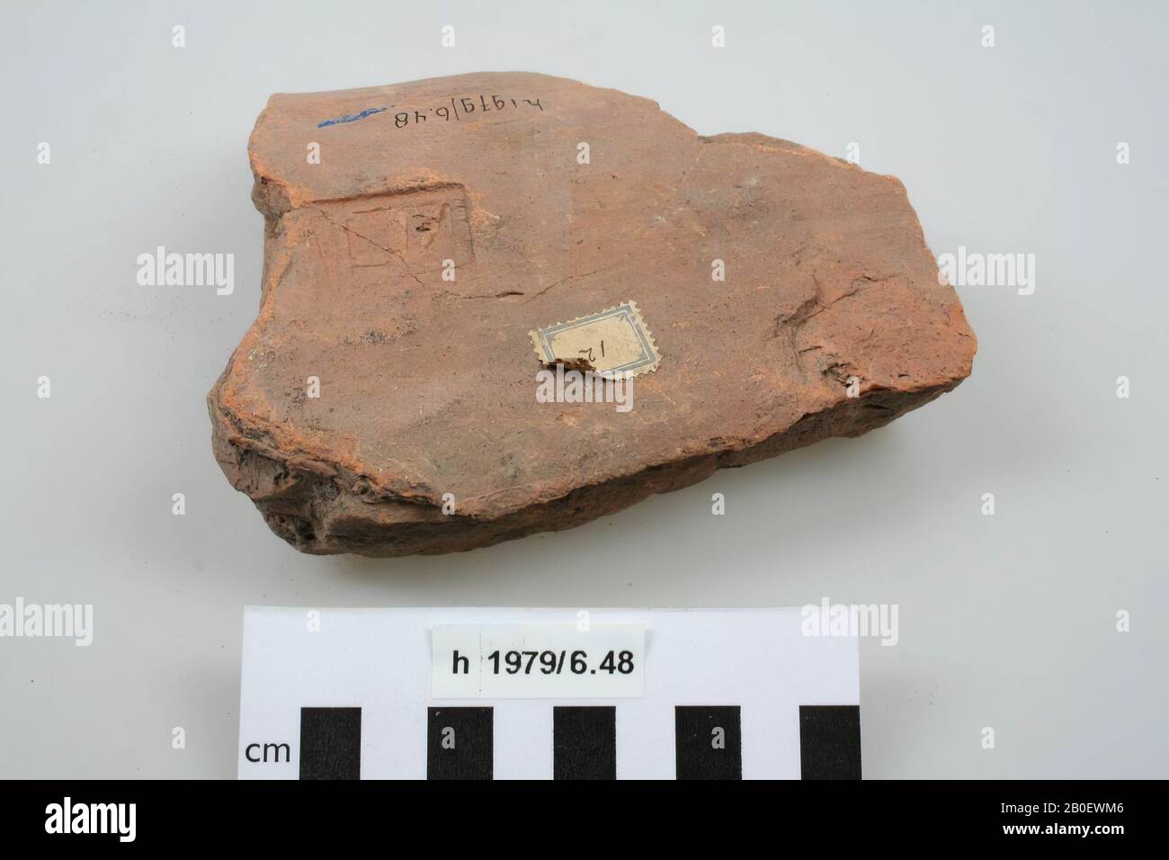 Fragment of an imbrex of brick with stamp NFR. Superficial crack, roof ...