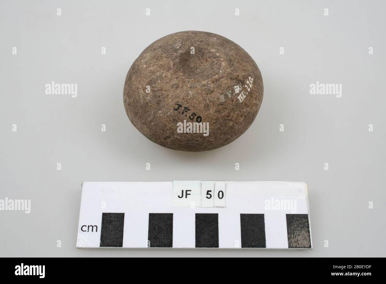 Granite disk with a dimple in the middle on both flats., Tool, stone ...