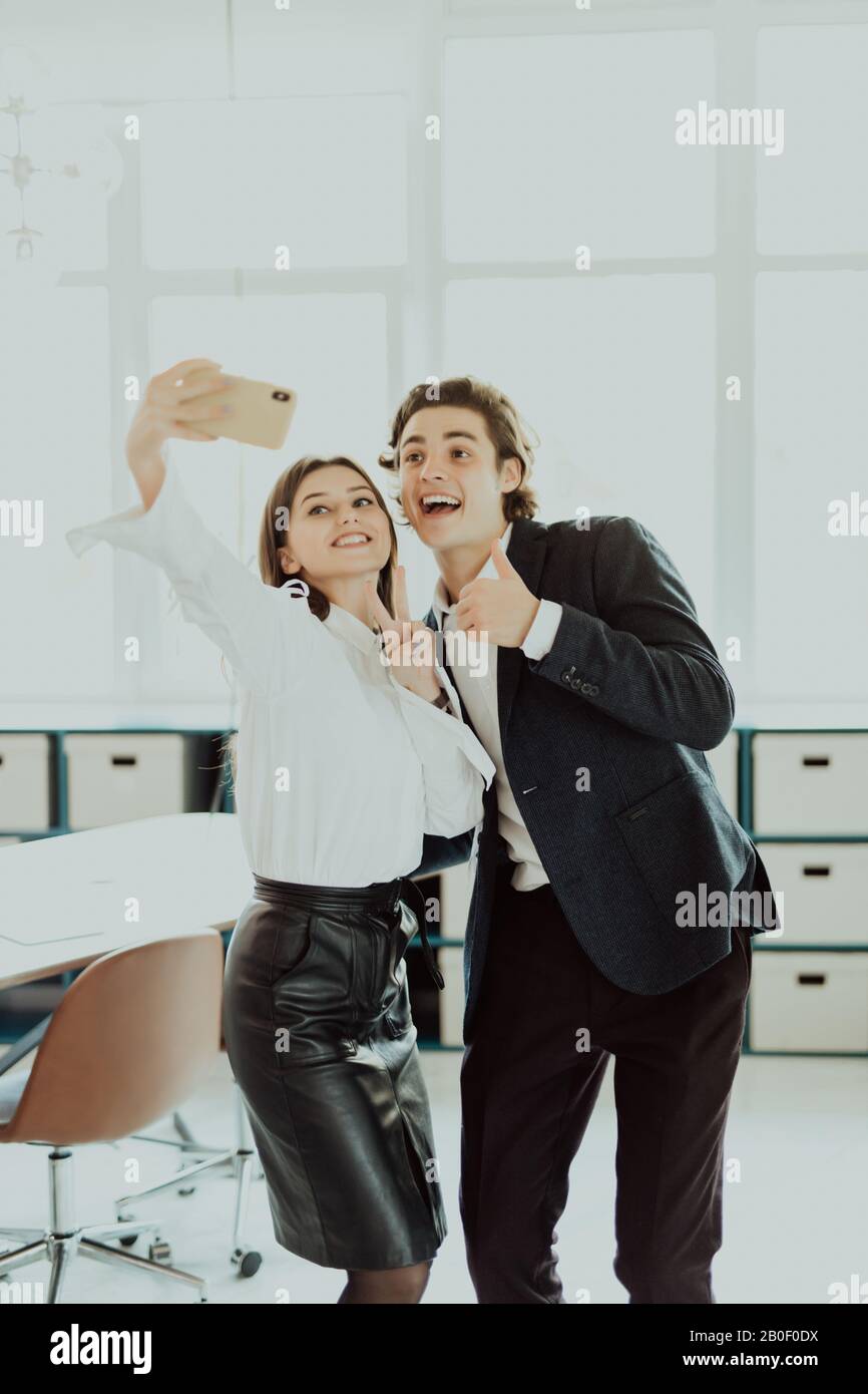 Young business team taking a selfie in office Stock Photo - Alamy
