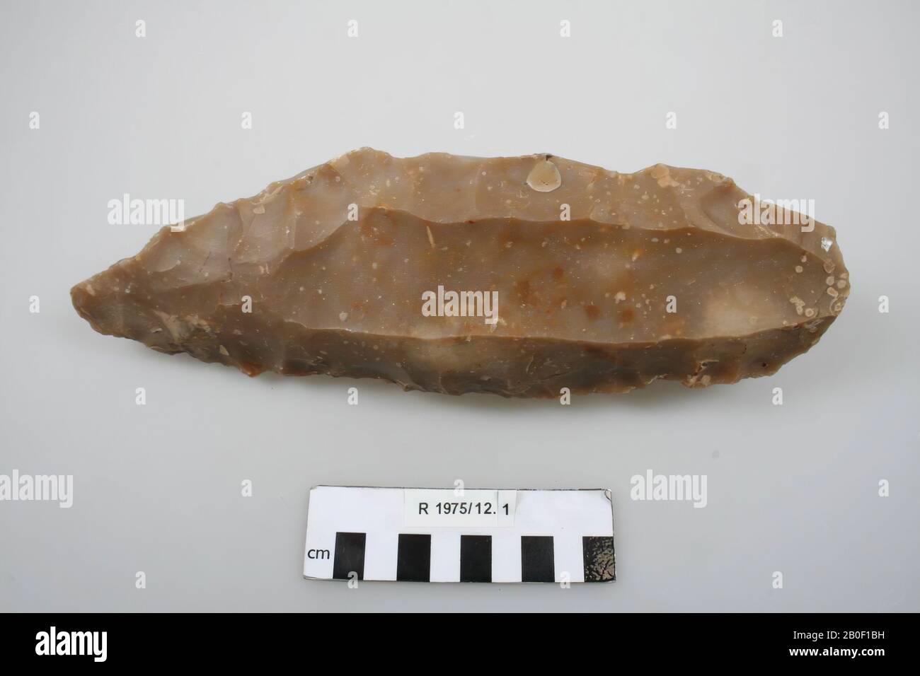 Large piece of modified flint with a deep hole that looks like a bore ...