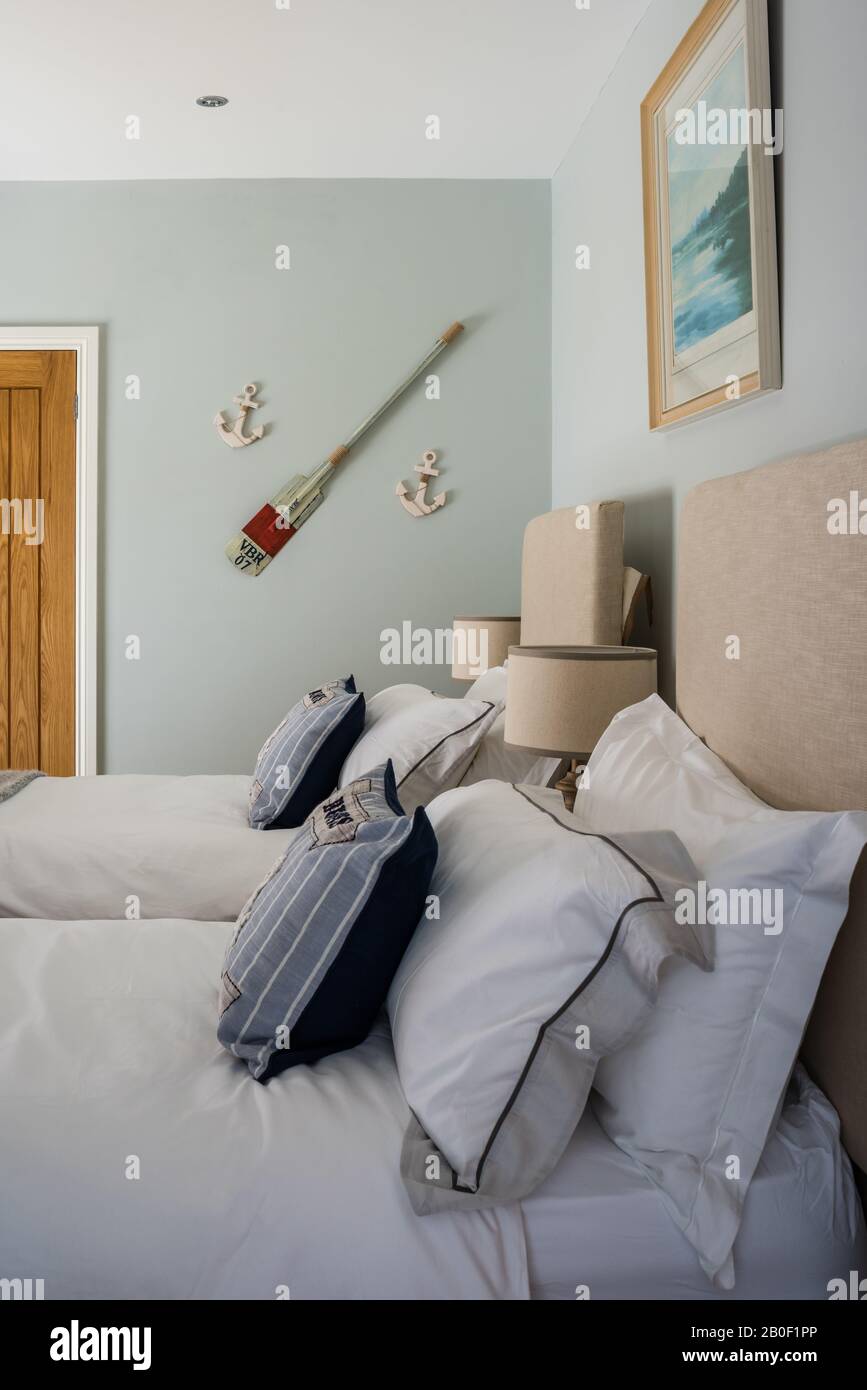 Painted wooden oar, with nautical-themed cushions and bed linen from ...
