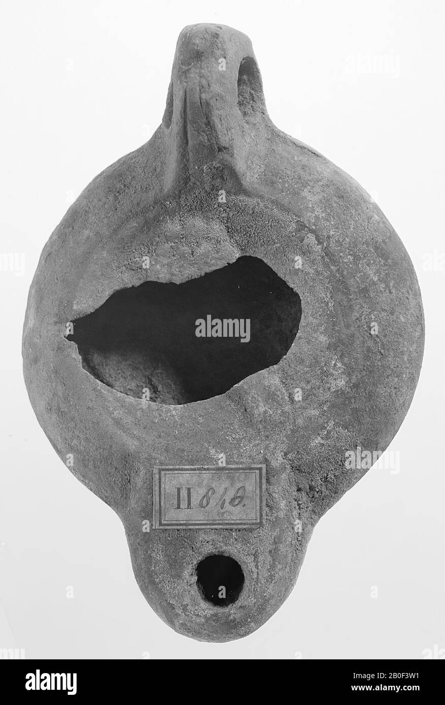 oil lamp with a spout and vertical ear, oil lamp, earthenware ...