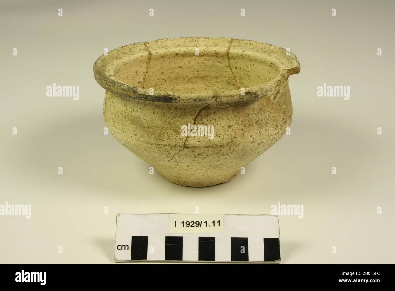 Small, rough-walled cooking pot with bent wall. Part of the rim is ...