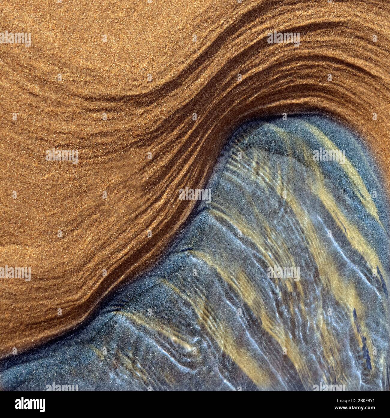 Abstract detailed tidal patterns in the sand at low tide on Penbryn ...