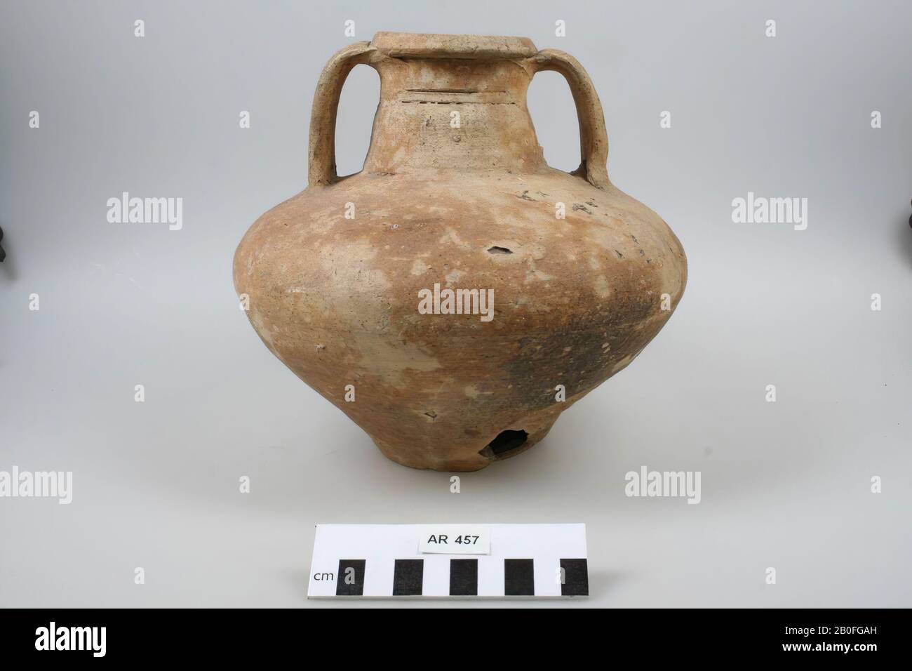 Jug with 2 ears of earthenware. Hole and surface damage at the wall ...