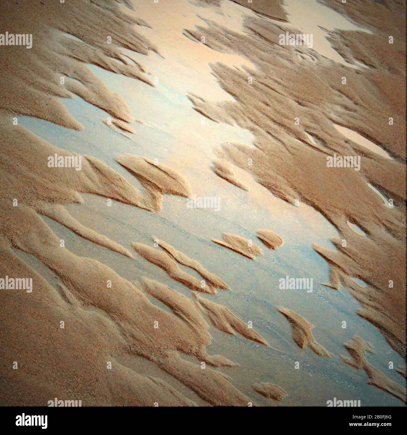 Abstract detailed tidal patterns in the sand at low tide on Penbryn ...