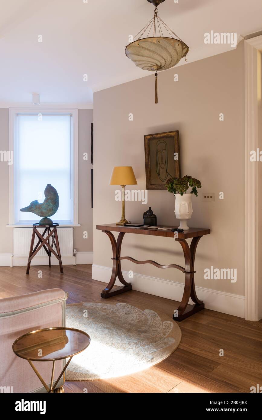 Elegant hall with Wave Stretcher table, by Soane Britain and bronze ...