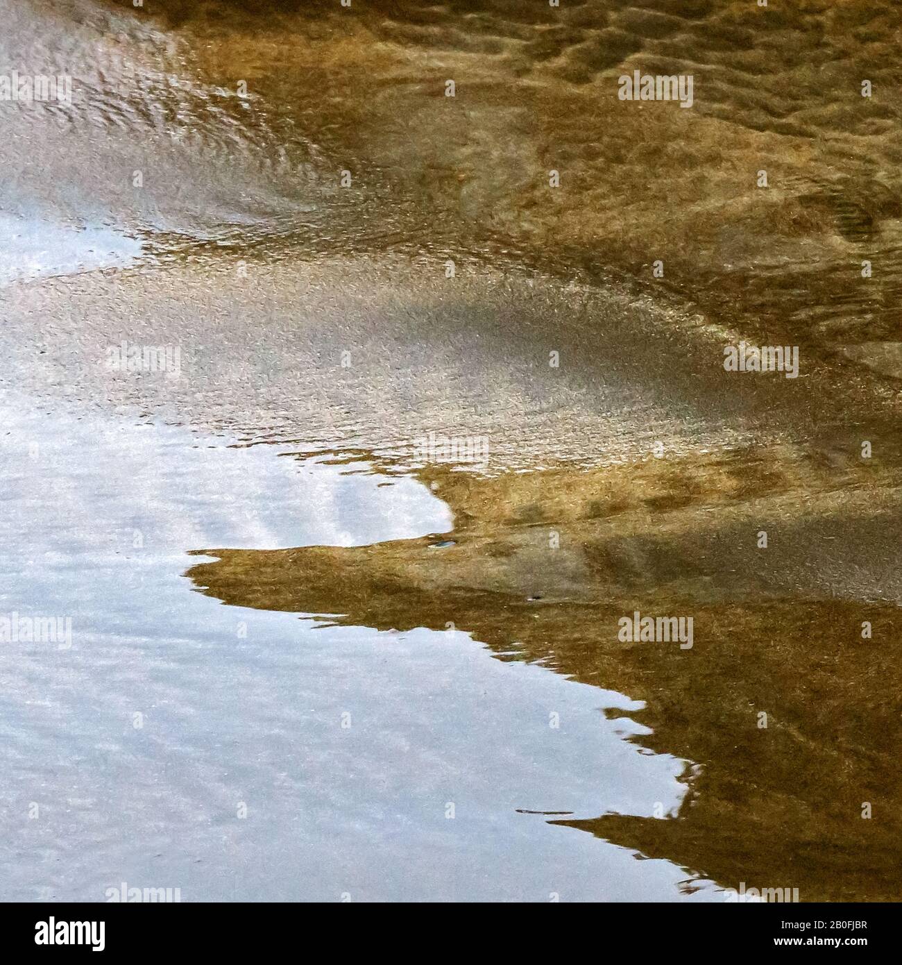 Abstract detailed tidal patterns in the sand at low tide on Penbryn ...