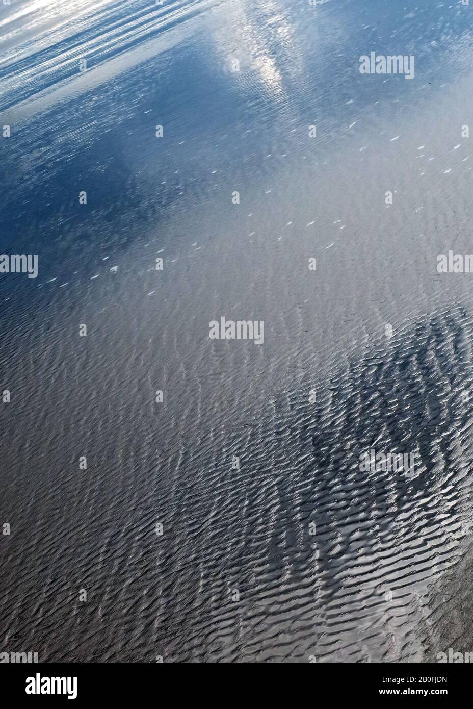 Abstract detailed tidal patterns in the sand at low tide on Penbryn ...