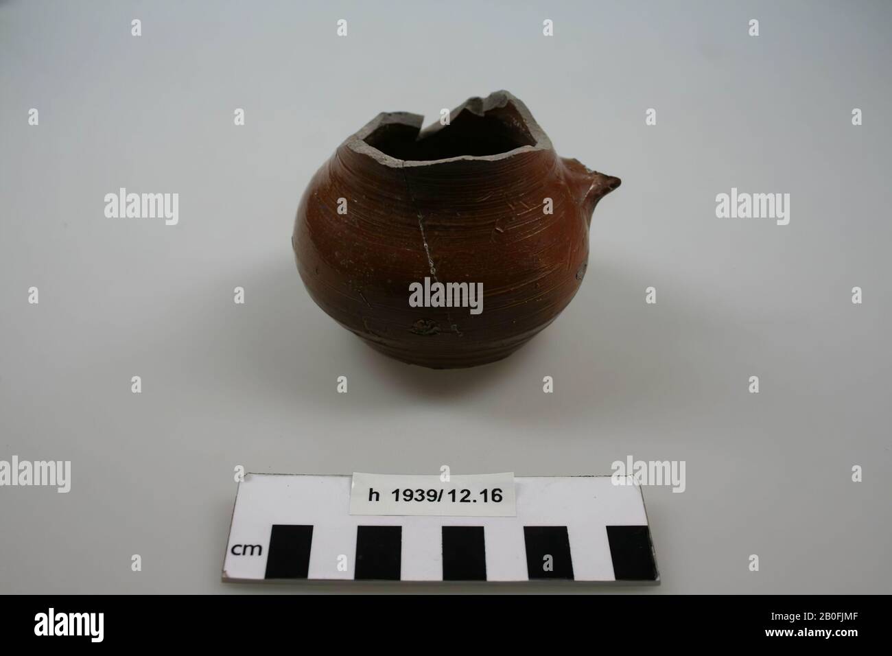 Cup, brown lead glaze. Top is missing, ear is missing. Old bonding and ...