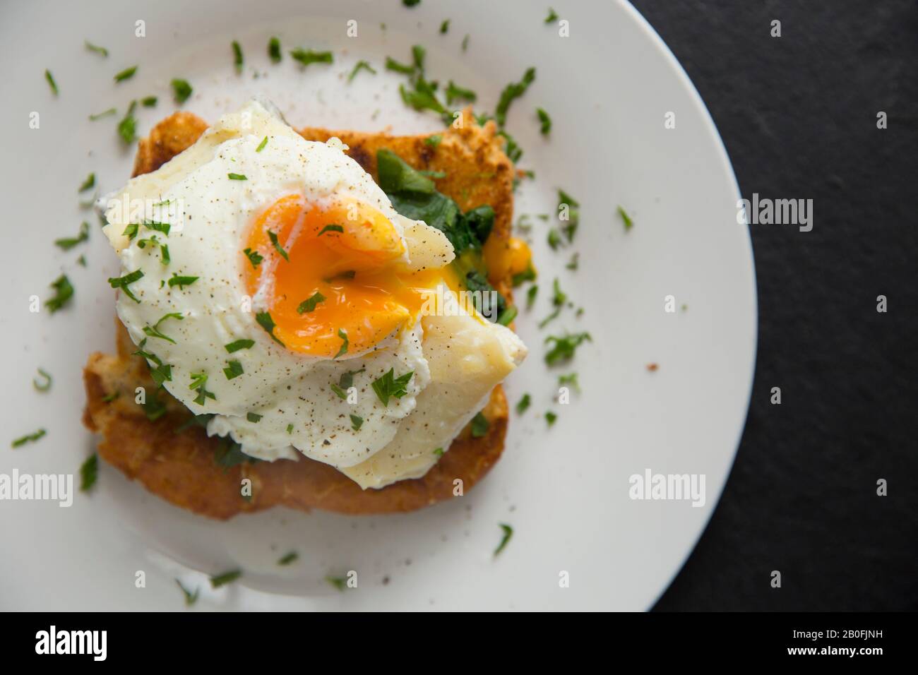 A poached egg served on top of a smoked, undyed haddock fillet ...