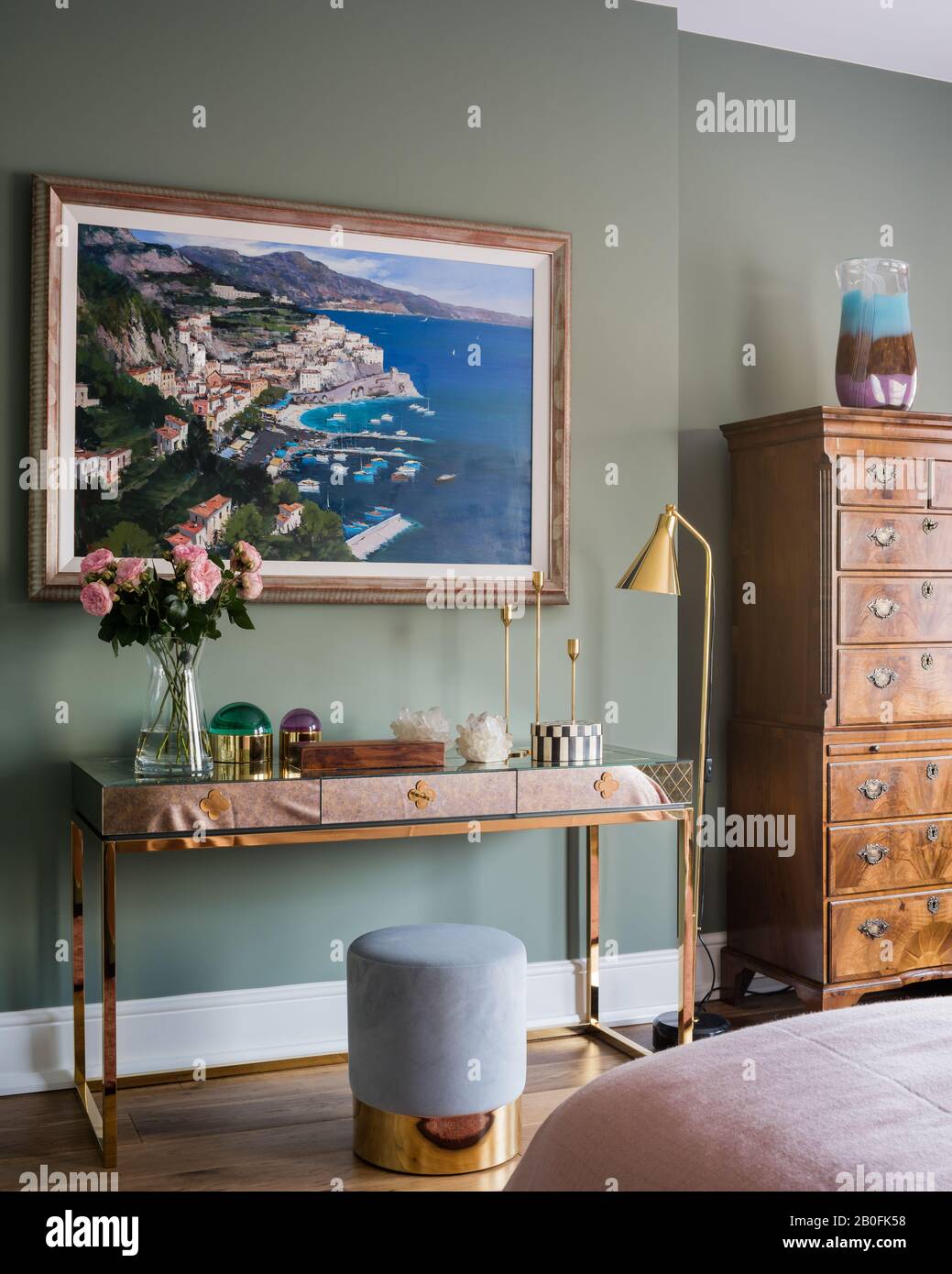 Framed print above console with tallboy Stock Photo - Alamy