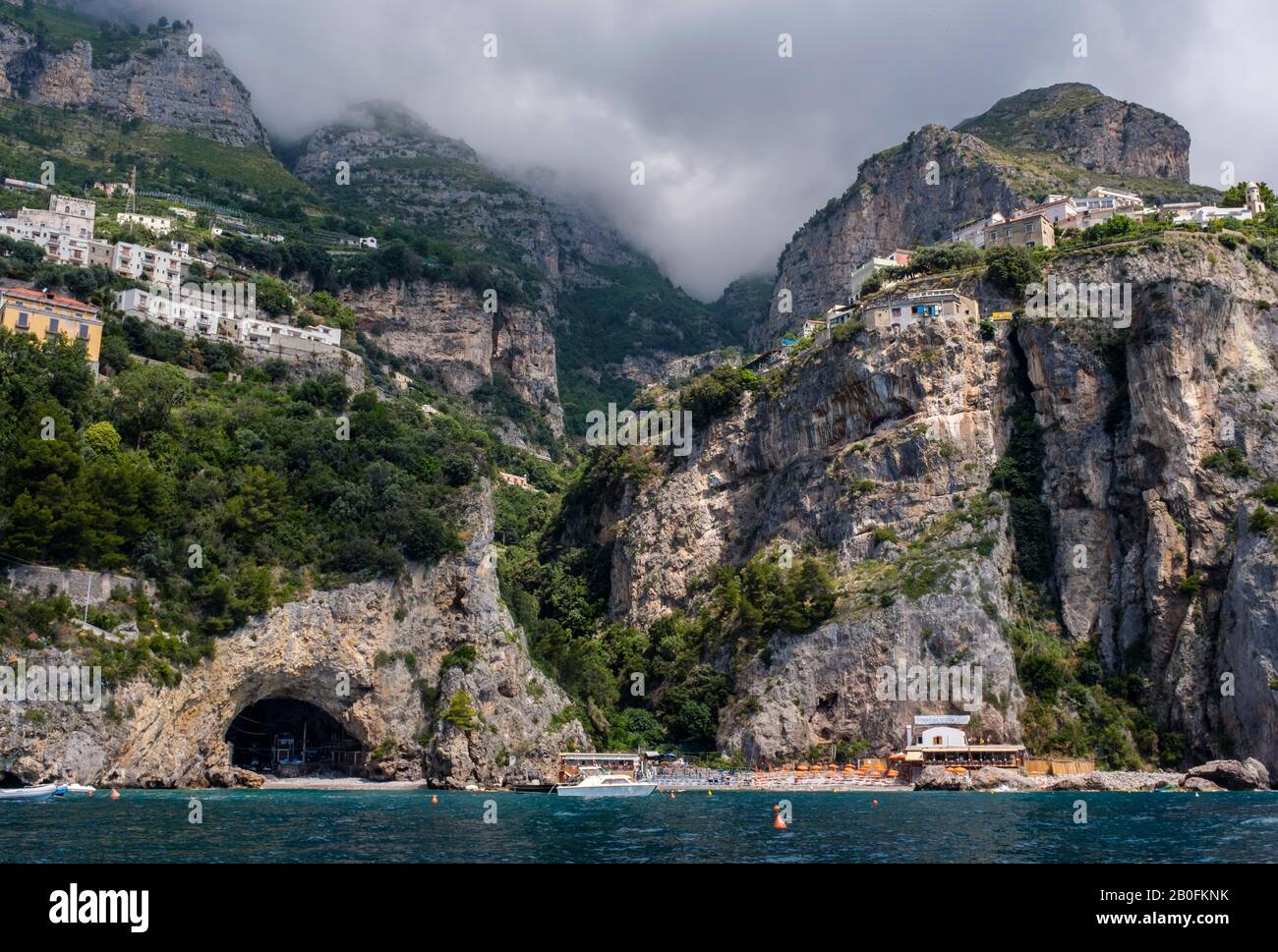 A cave in the sheer rocky cliffs of the Amalfi Coast, Italy Stock Photo ...