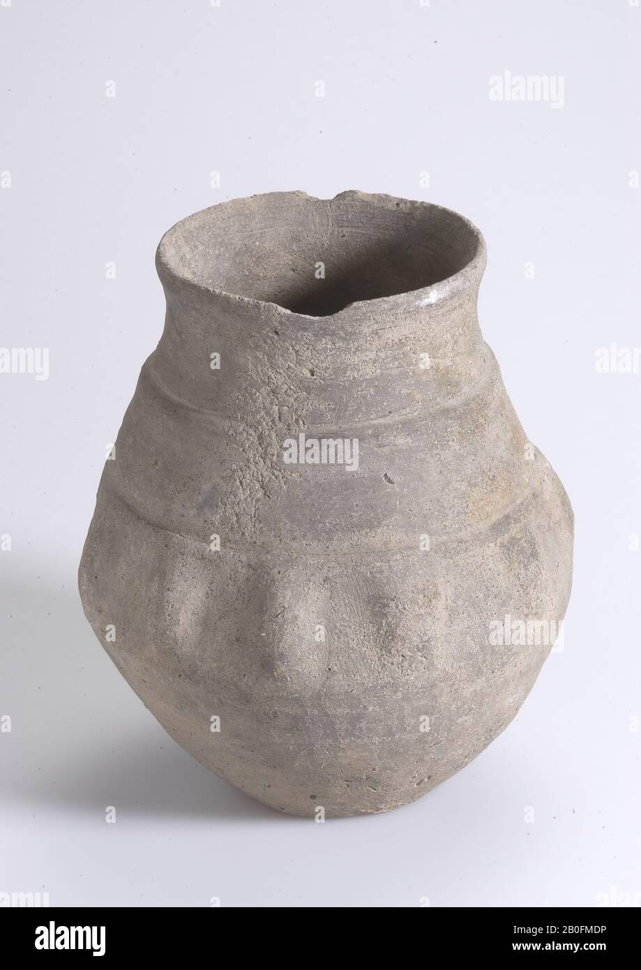 Pot or jug, coarsely brown-gray, neck with wide mouth. Around the belly ...