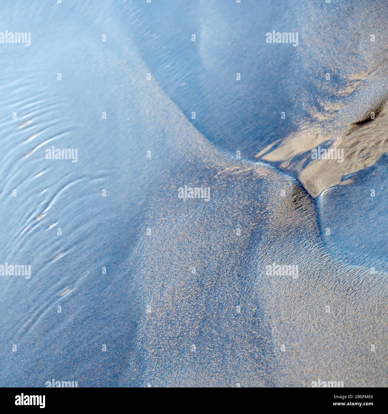 Abstract detailed tidal patterns in the sand at low tide on Penbryn ...