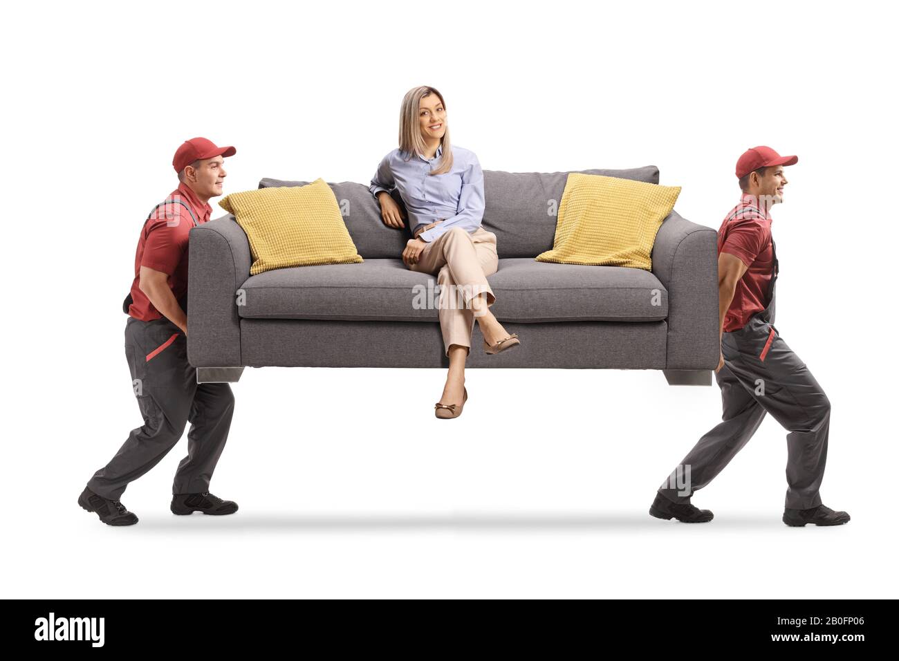 Movers carrying a sofa with a young woman sitting and smiling isolated ...