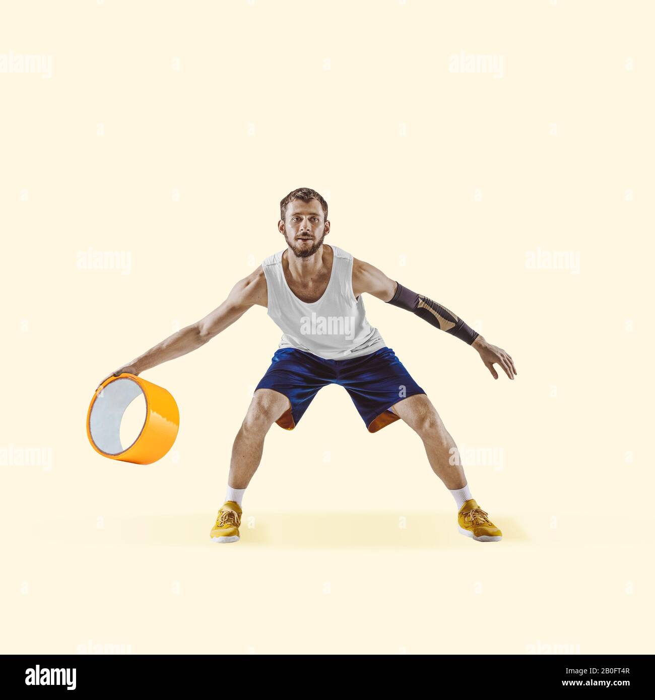 Basketball player with big duct tape on yellow background. Copyspace ...