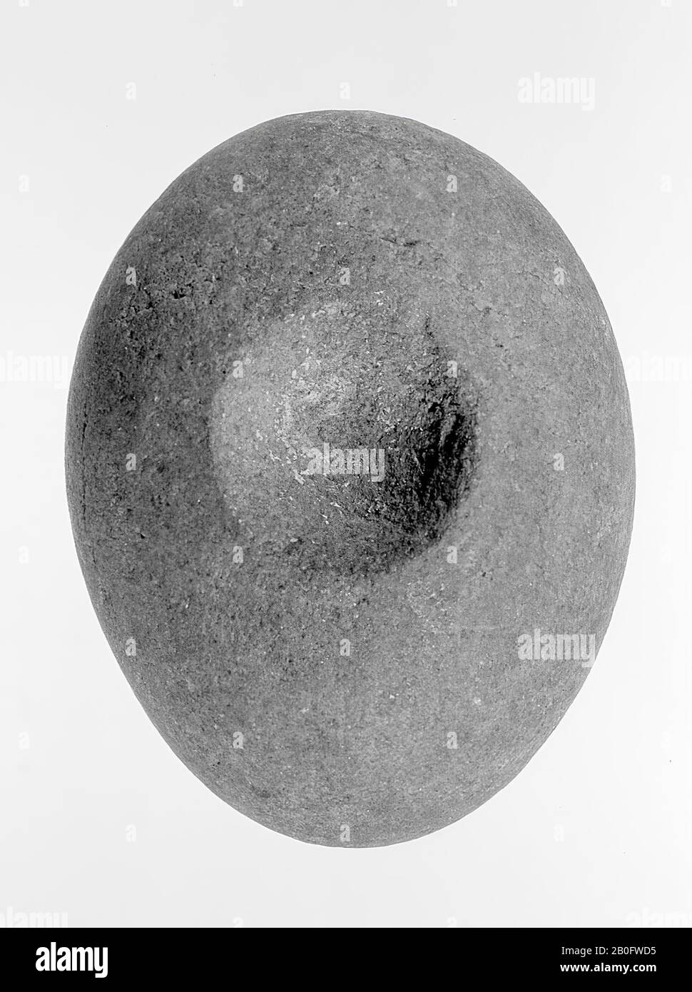 round boulder, in which a round cavity is placed above and below ...