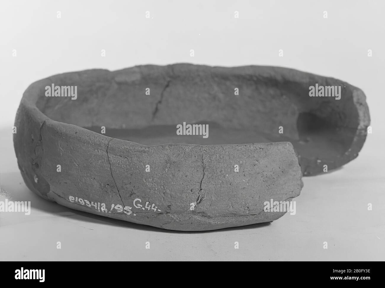 Dish of earthenware with flat bottom and upright edge. Part of the edge ...