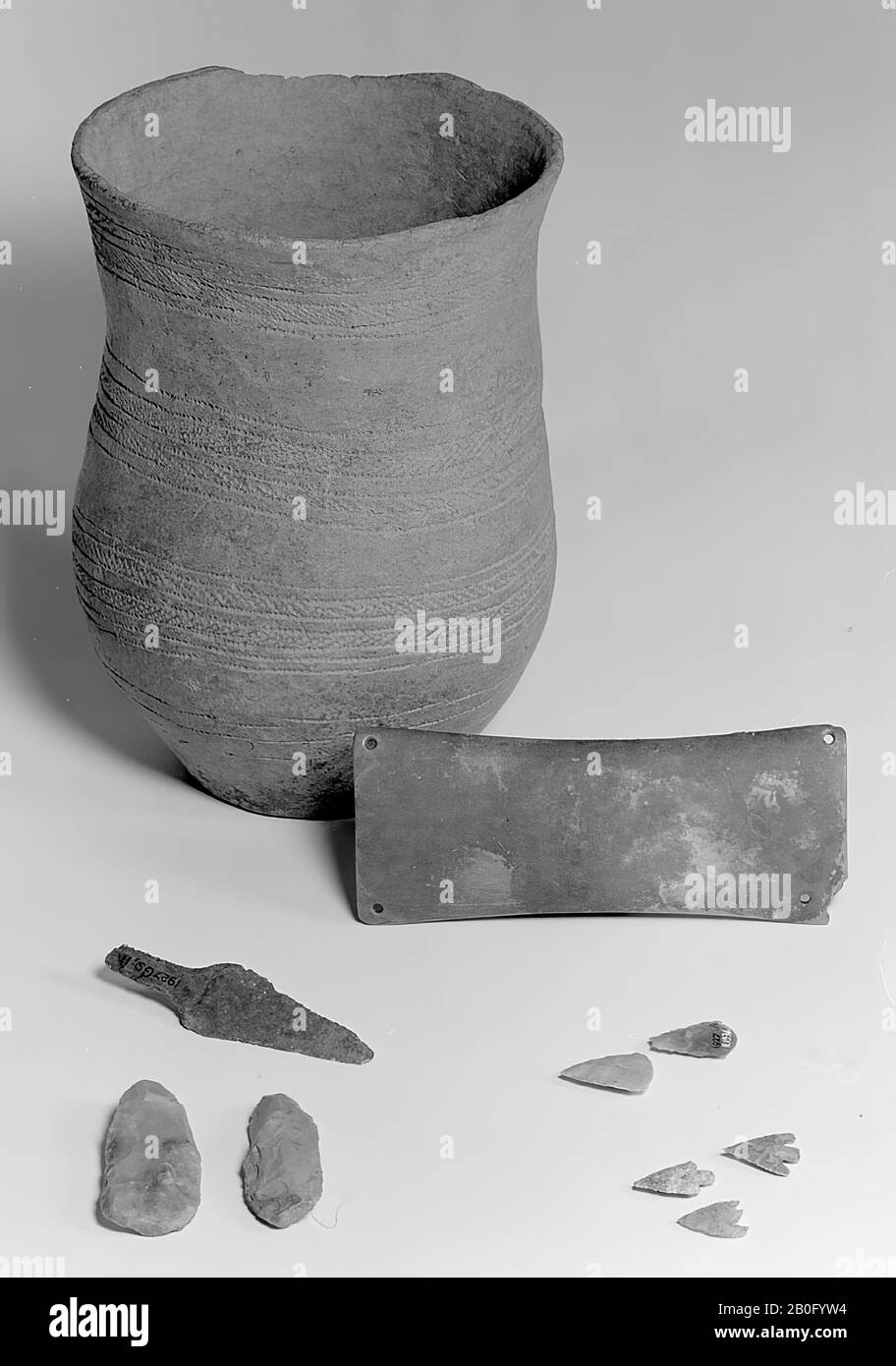 elongated piece of flint, retouched on the long sides. The shape ...