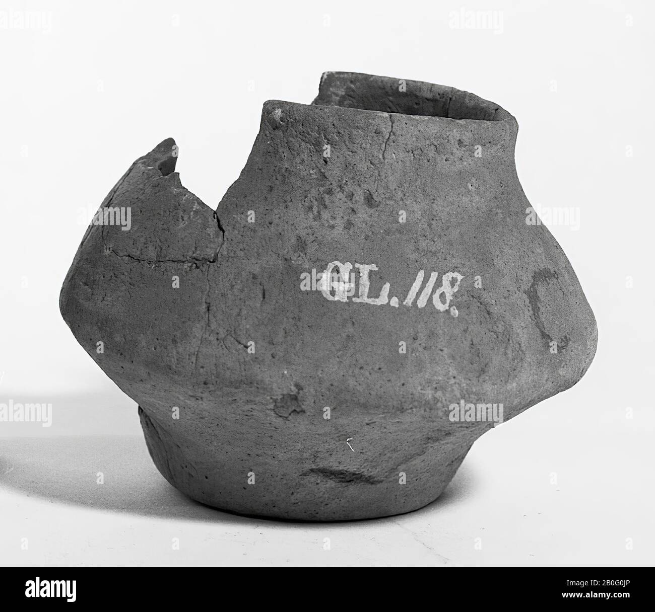 reddish pot with sharp bend from belly to shoulder. Damaged from above ...