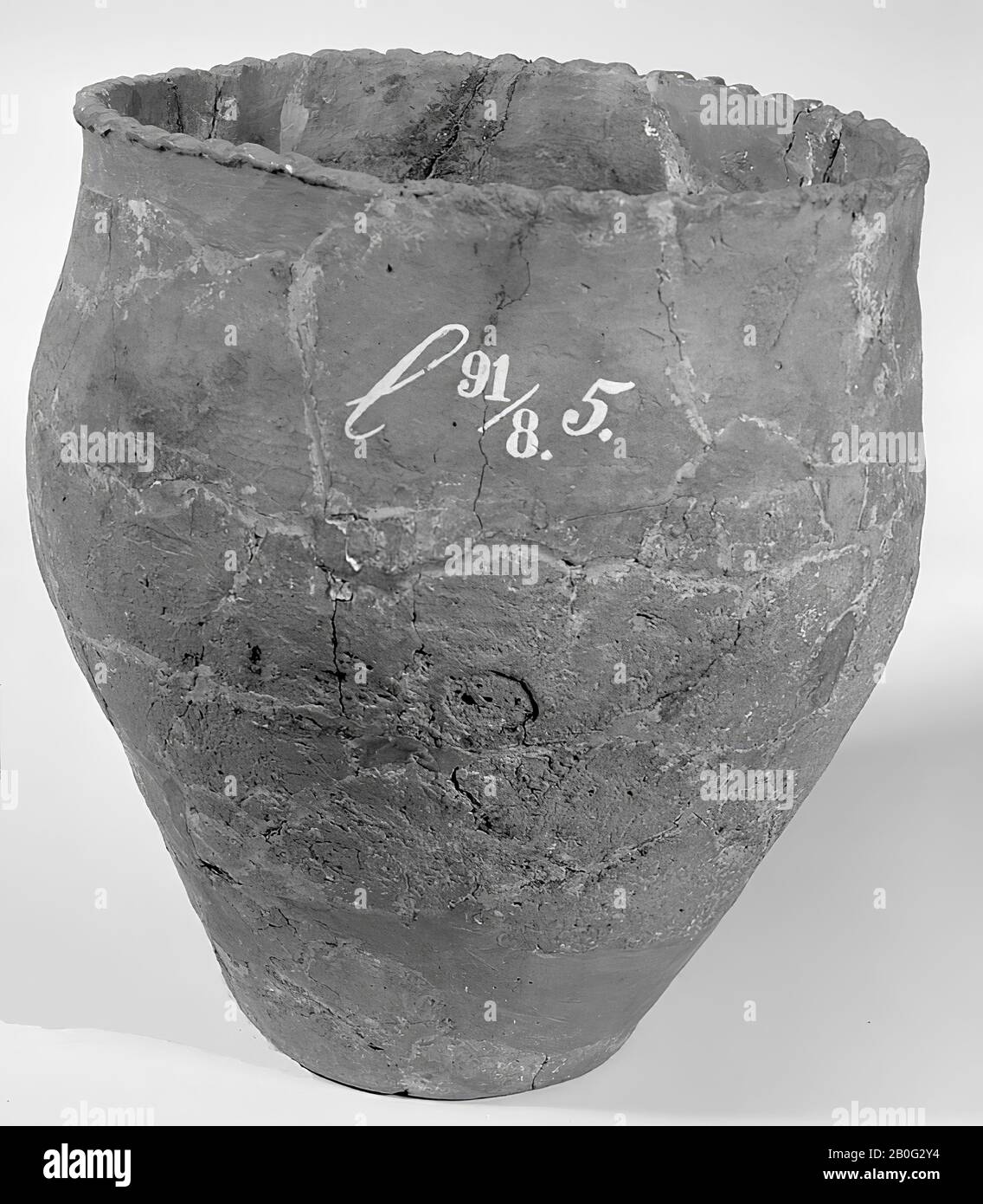 Cylindrical urn of earthenware with nail impressions on the edge. Old ...