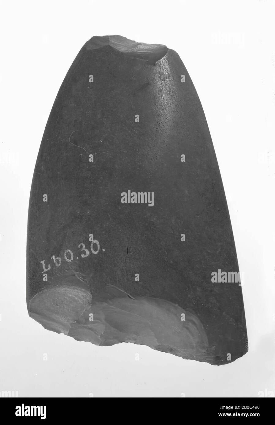 polished ax of flint, olive-colored, very smooth, damaged at the edge ...