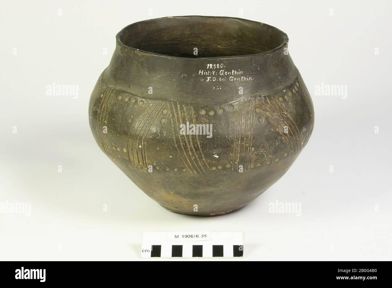 Casting of a jar with stamped circles and notched line decoration on ...